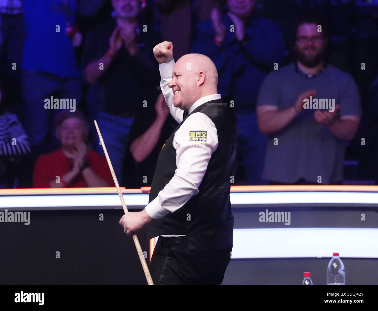 John Higgins celebrates his win against Judd Trump on day seven of the ...