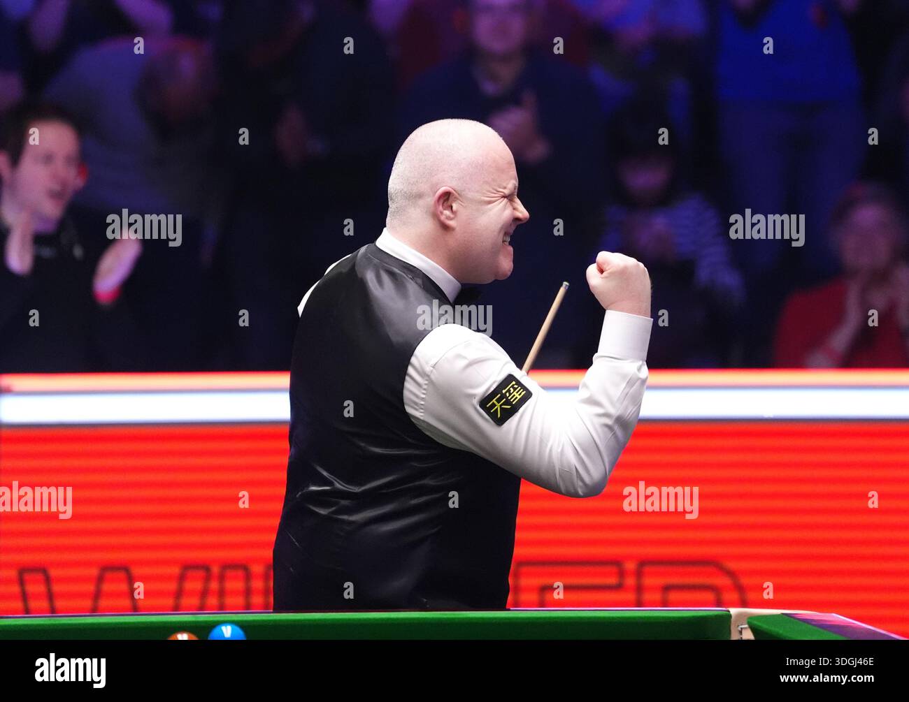 John Higgins celebrates his win against Judd Trump on day seven of the ...