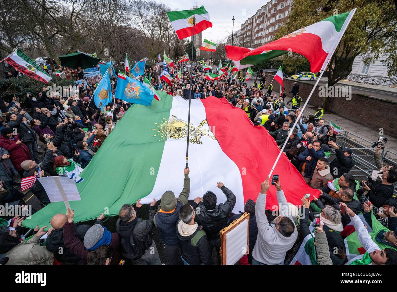 London, UK. 17 January 2026. Protesters hold a giant national flag ...