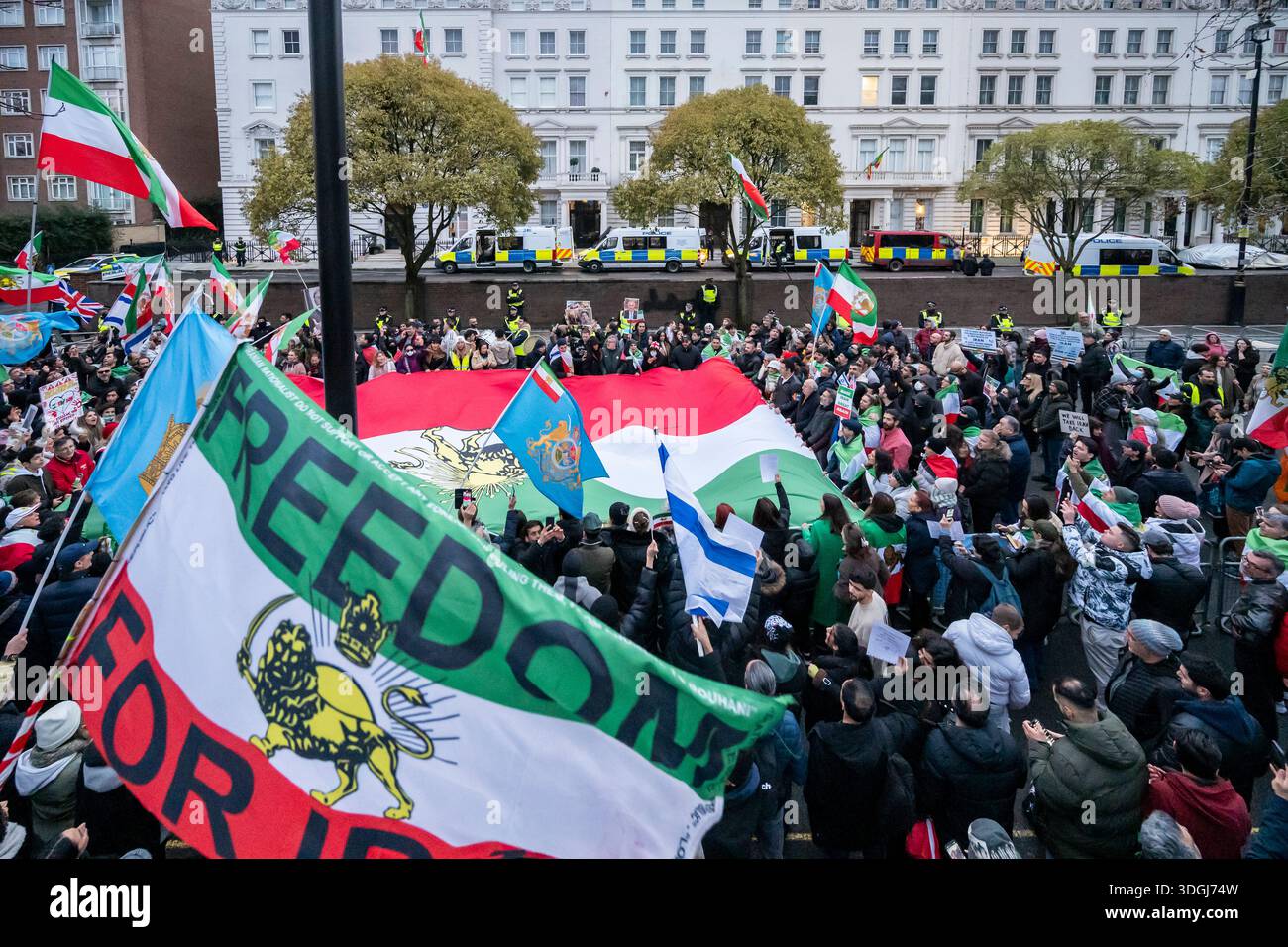 London, UK. 17 January 2026. Protesters hold a giant national flag ...