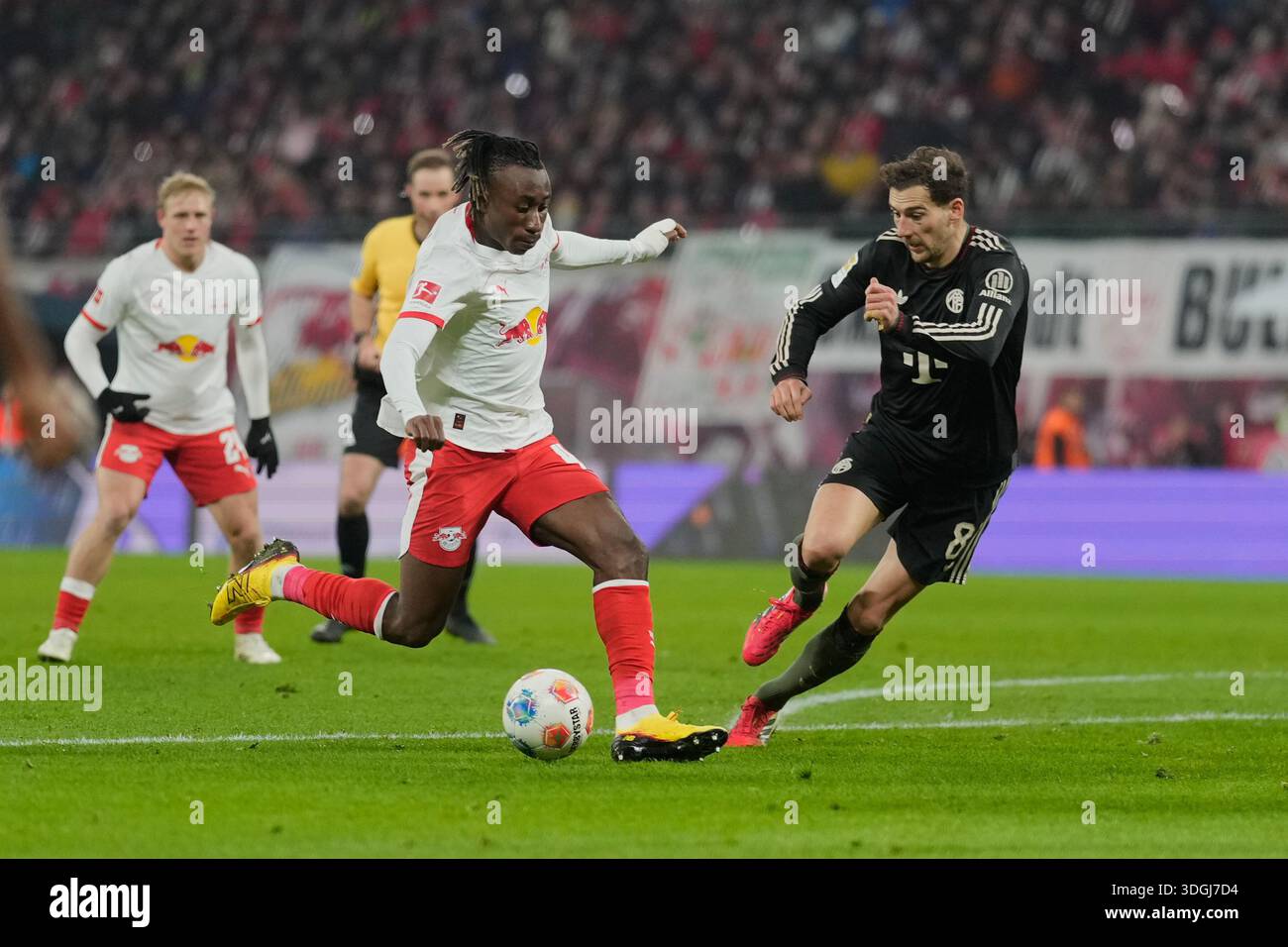 Leipzig's Yan Diomande and Bayern's Leon Goretzka challenge for the ...