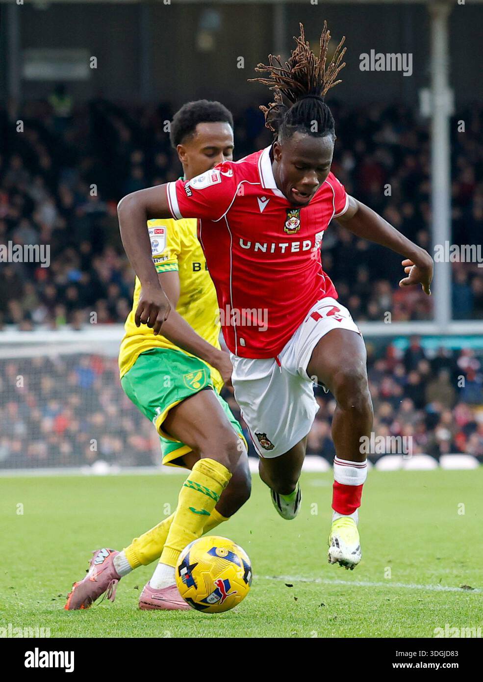 Wrexham's Issa Kabore and Norwich City's Ali Ahmed battle for the ball ...