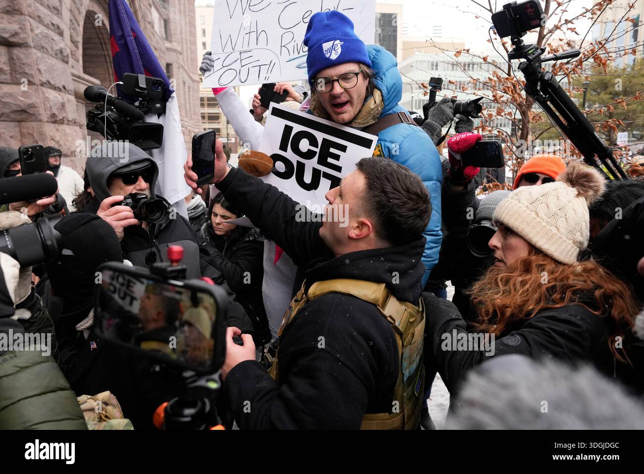 Pro-immigration protesters confront Jake Lang, center, who organized ...