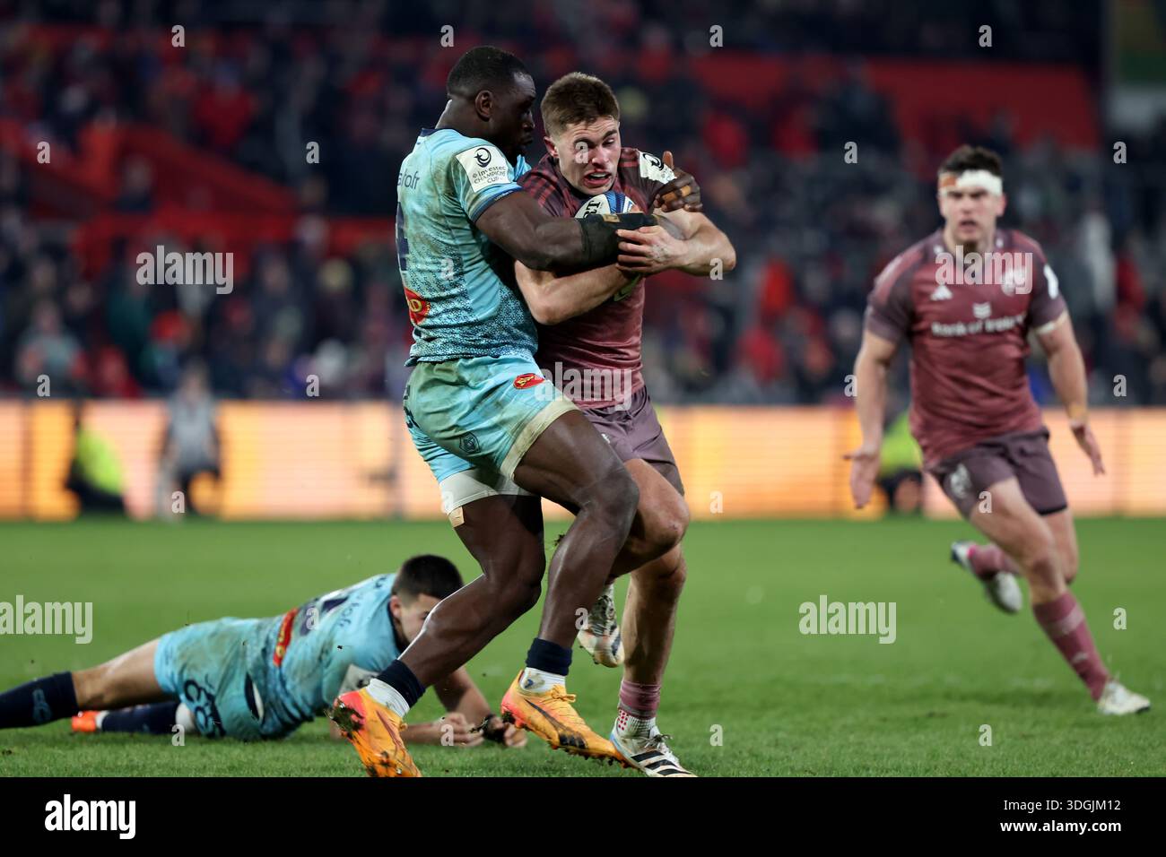 Munster Rugby's Jack Crowley (right) is tackled by Castres' Christian ...