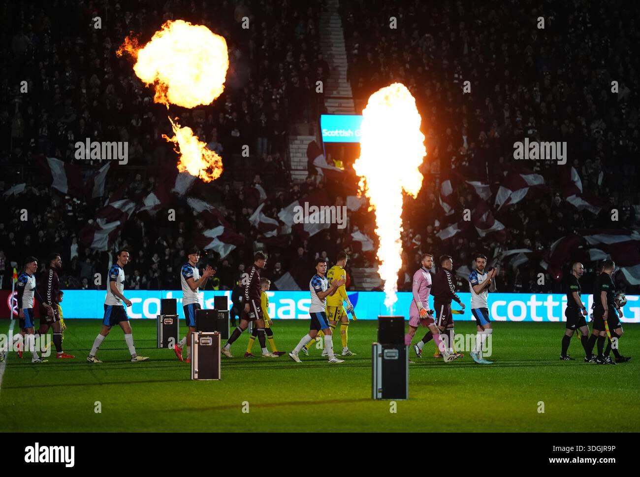 Pyrotechnics are set off as the teams walk onto the pitch ahead of the ...