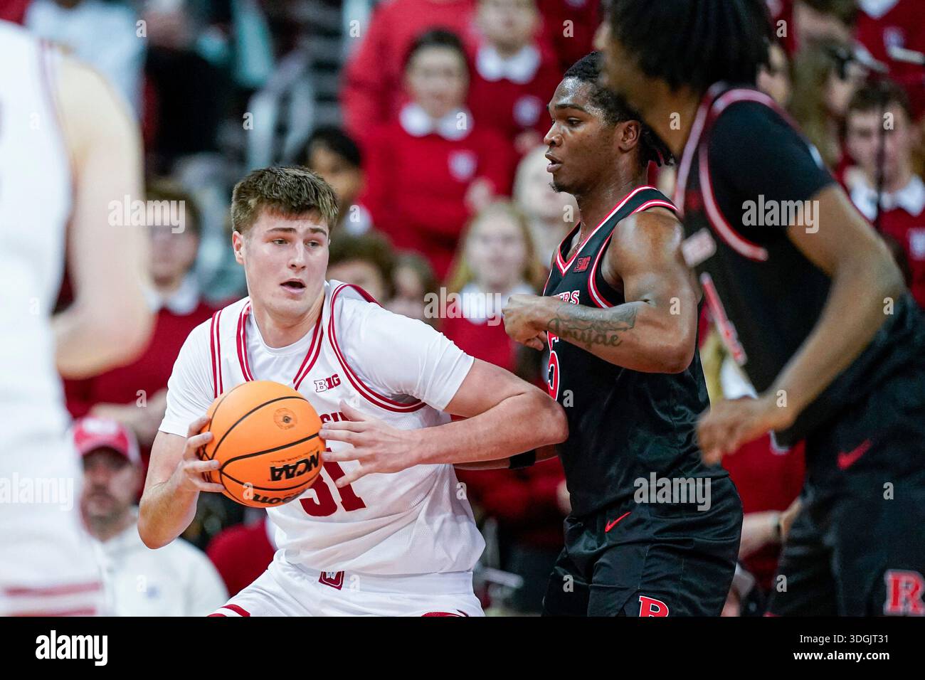 Wisconsin's Nolan Winter (31) drives against Rutgers' Darren Buchanan ...