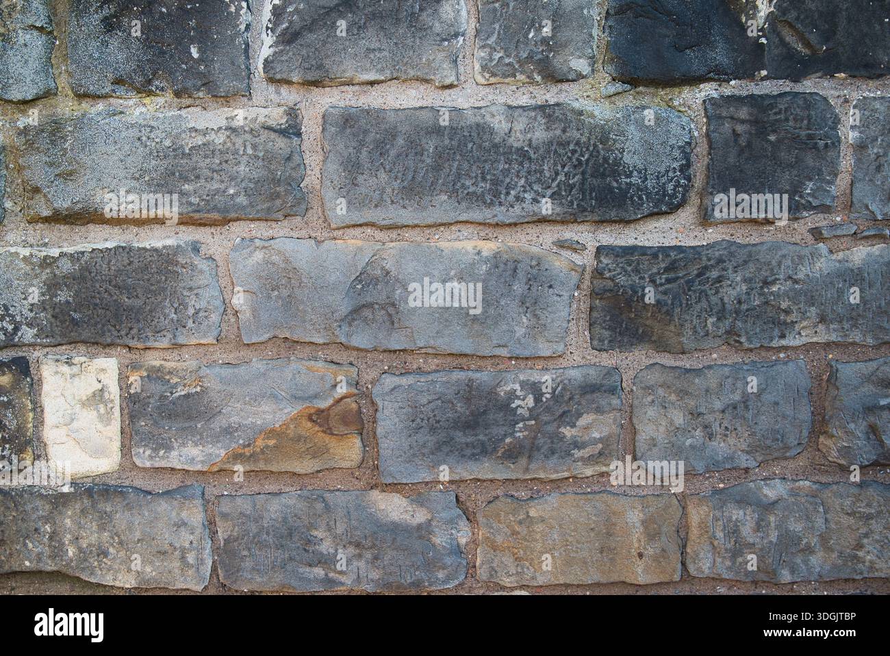 Clean, rectangular slate-colored stone blocks with visible mortar lines ...