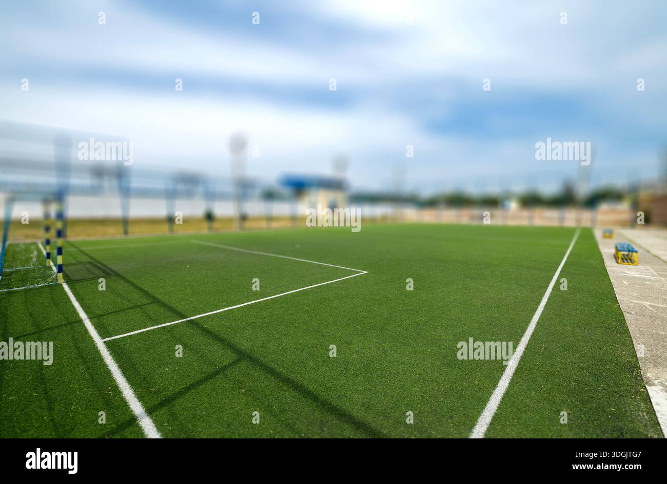 A mini soccer field with artificial turf, white boundary lines, and ...