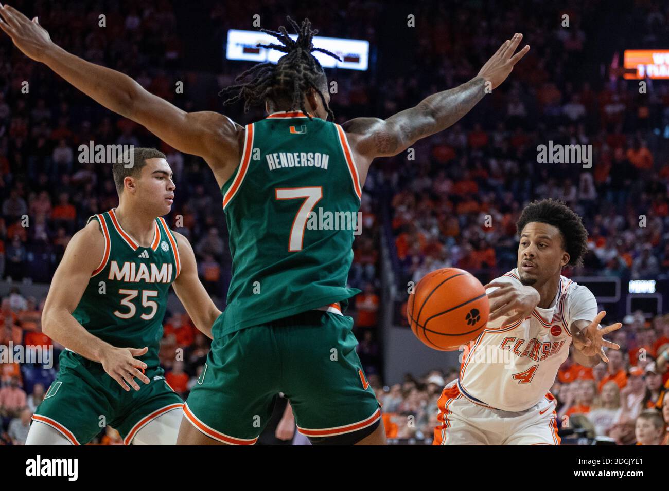 Clemson guard Efrem Johnson (4) passes around Miami forward Shelton ...