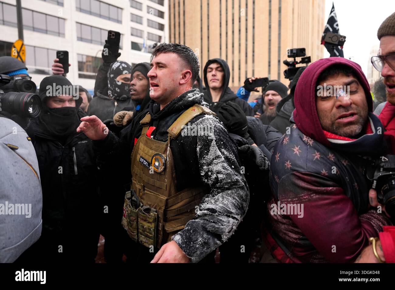 Jake Lang, center, who organized the March Against Minnesota Fraud ...