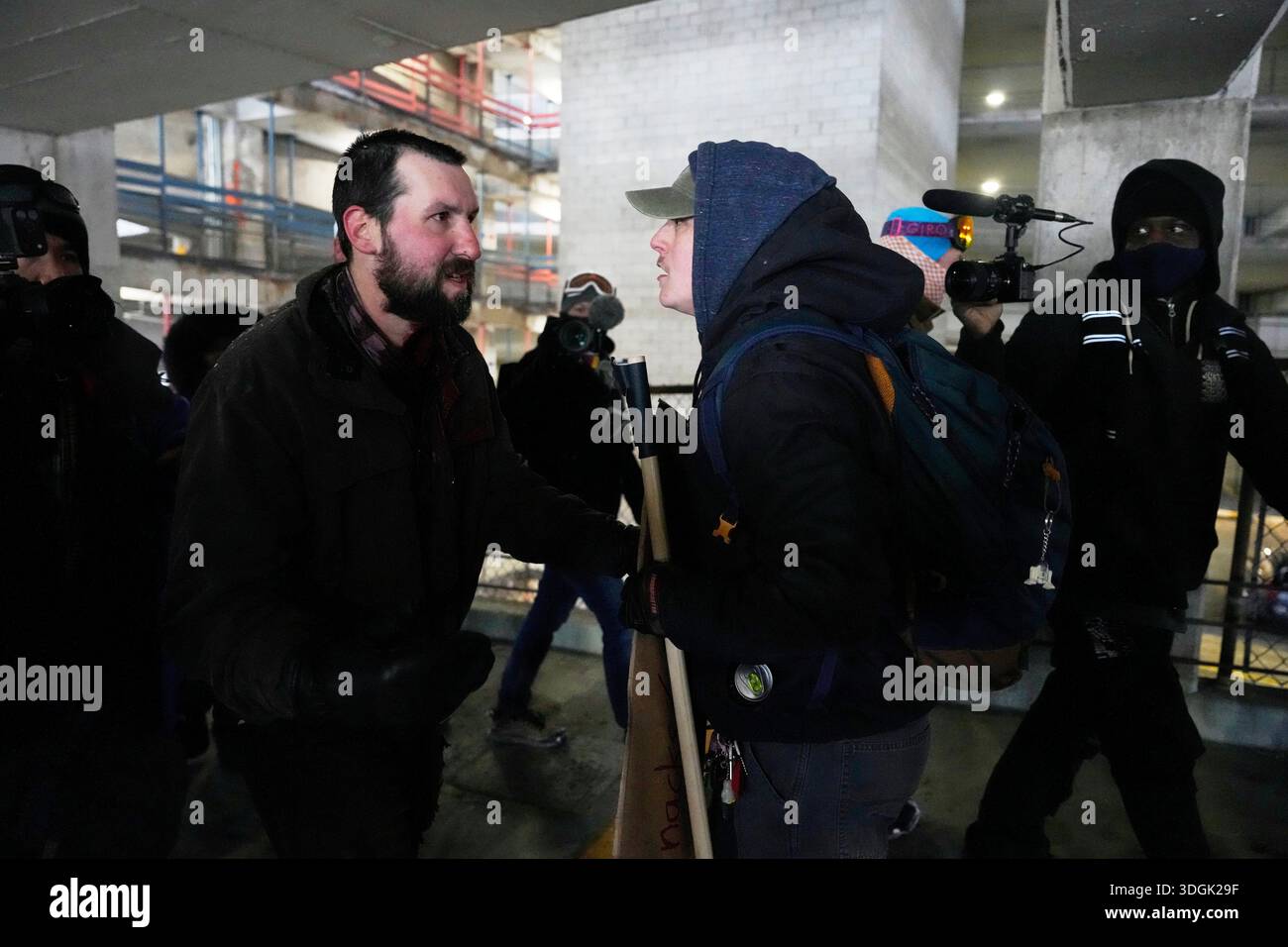 A Jake Lang supporter is confronted by a pro-immigration protester ...