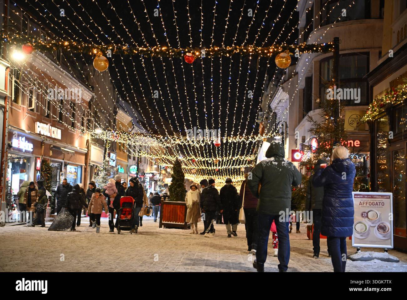 BRASOV, winter People enjoy the snow in Piata Sfatului in Brasov ...