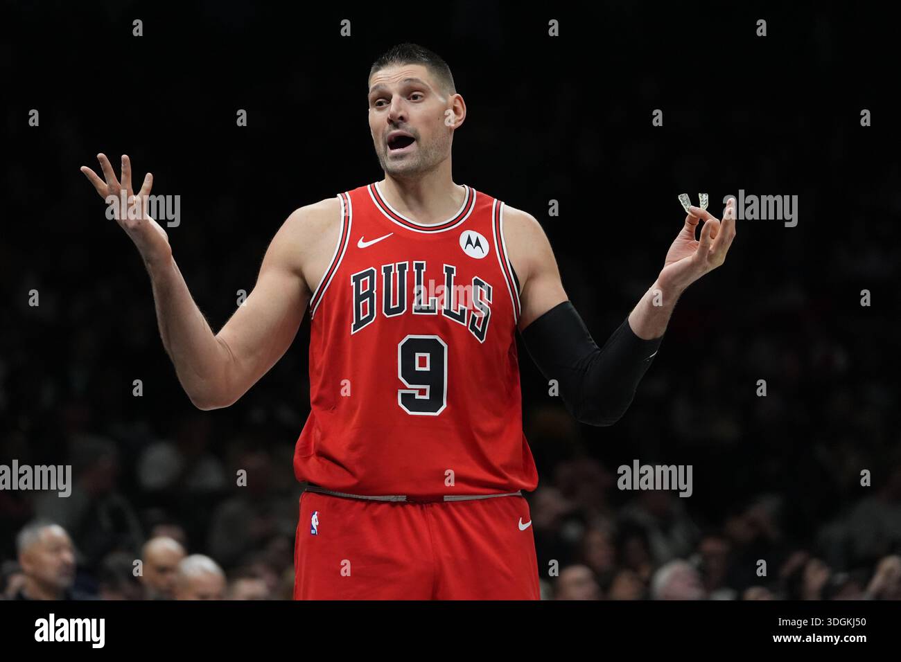 Chicago Bulls' Nikola Vucevic (9) gestures while talking to a fan ...