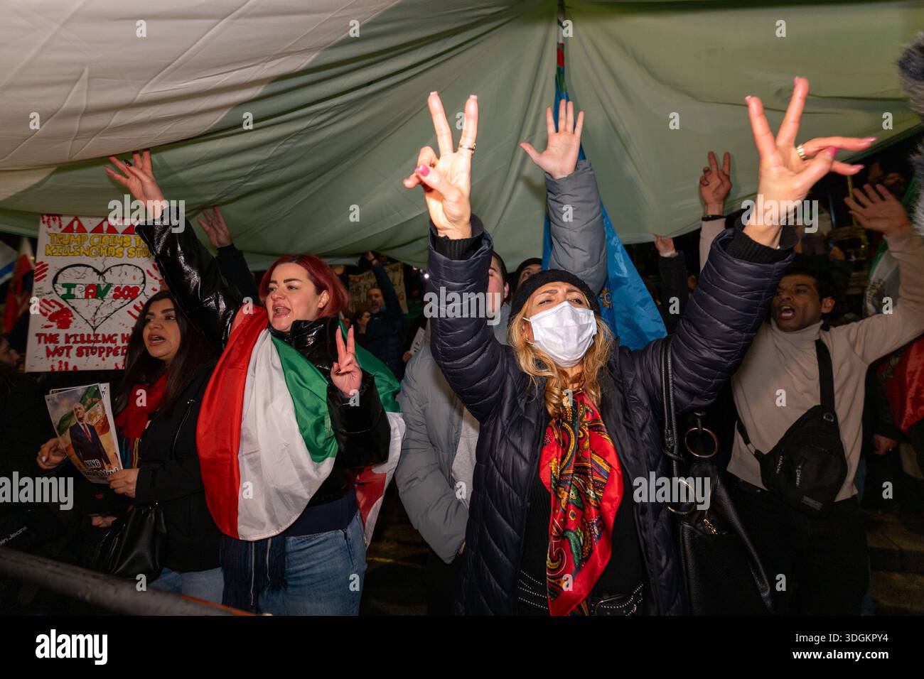 London, UK. 17th Jan, 2026. A protesters chanting while standing under ...