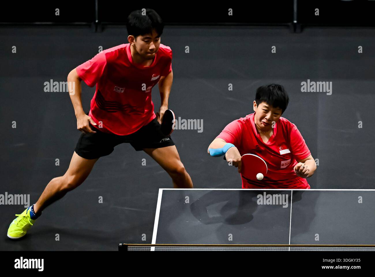 Pang Koen and Zeng Jian of Singapore in action against Wong Chun Ting ...