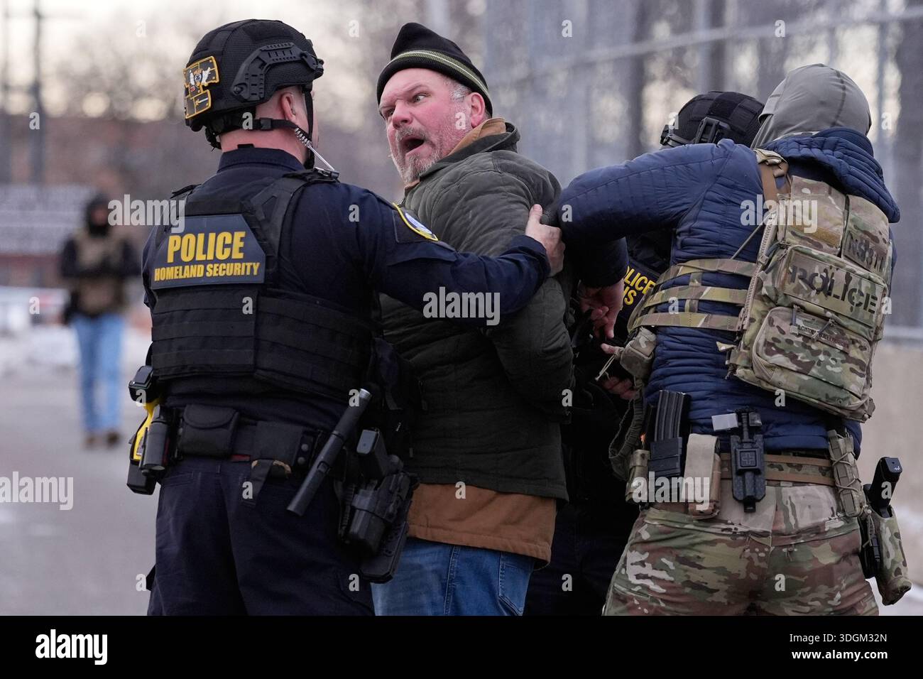 Law enforcement detain a man outside the Bishop Henry Whipple Federal ...