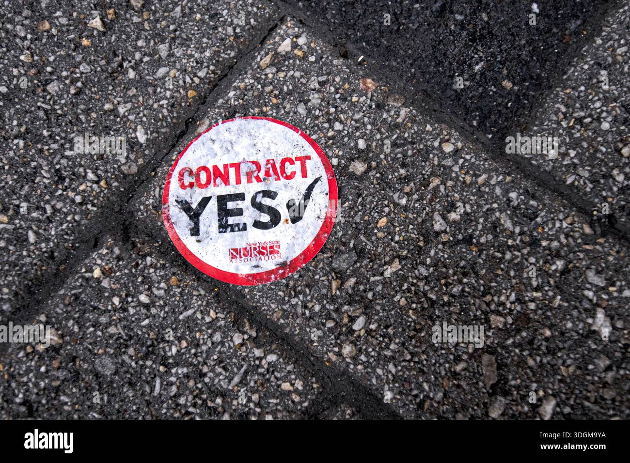 A discarded sticker on the pavement as New York City nurses continue to ...