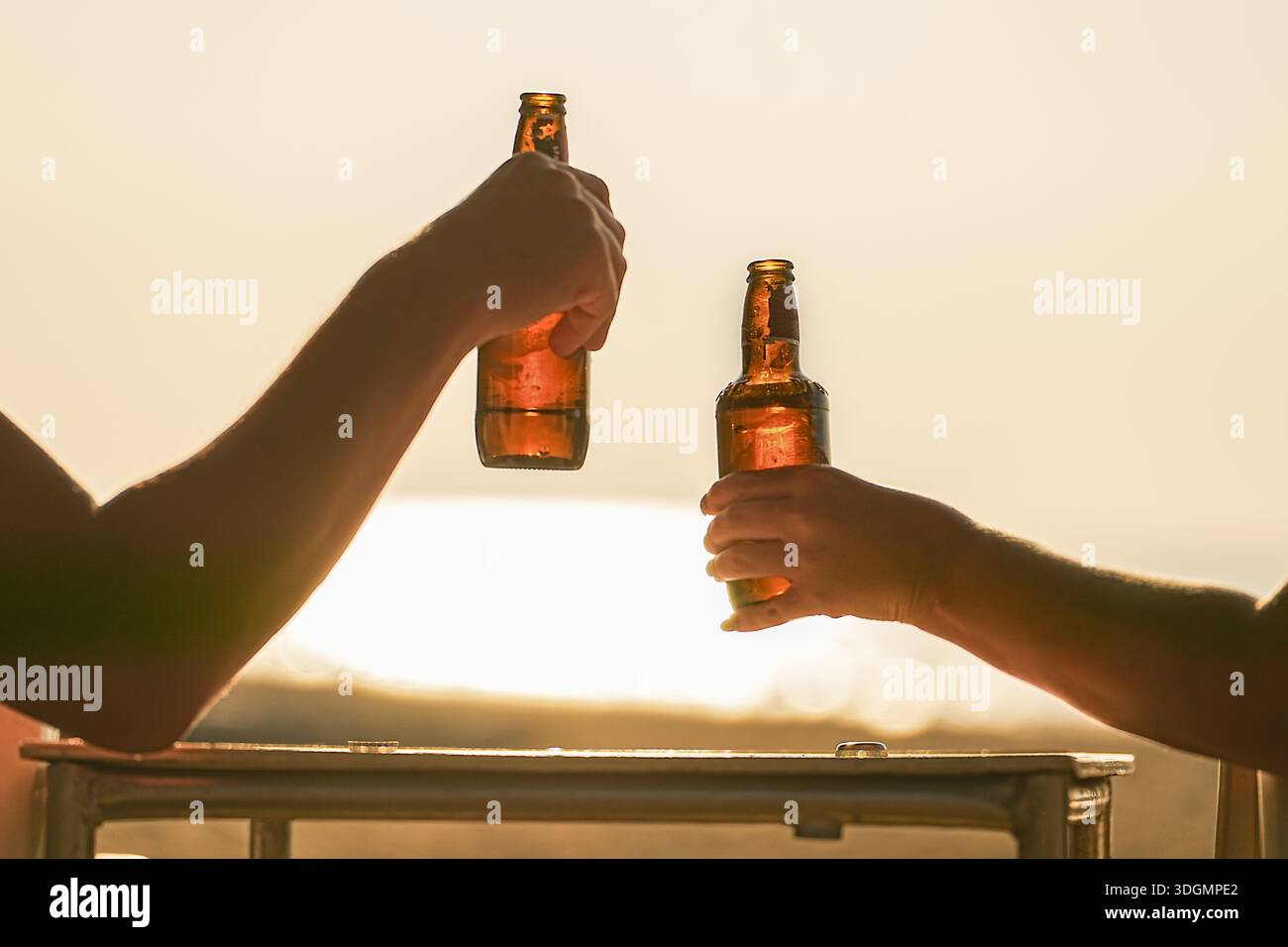 Two hands clink bottles beer hi-res stock photography and images - Alamy