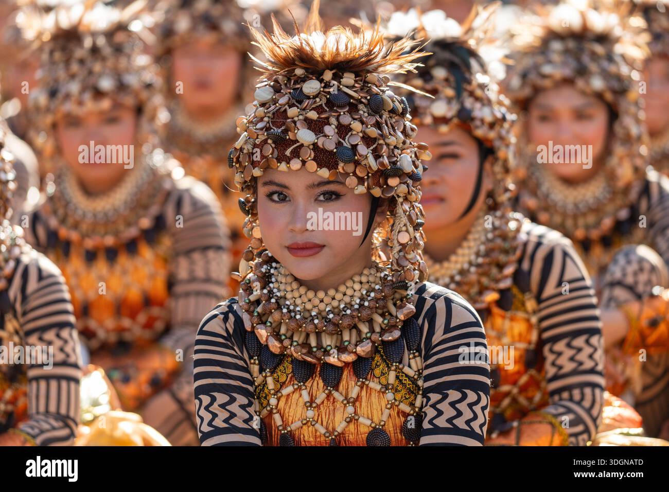 Portrait of a street dancer wearing a creative and colourful headdress ...