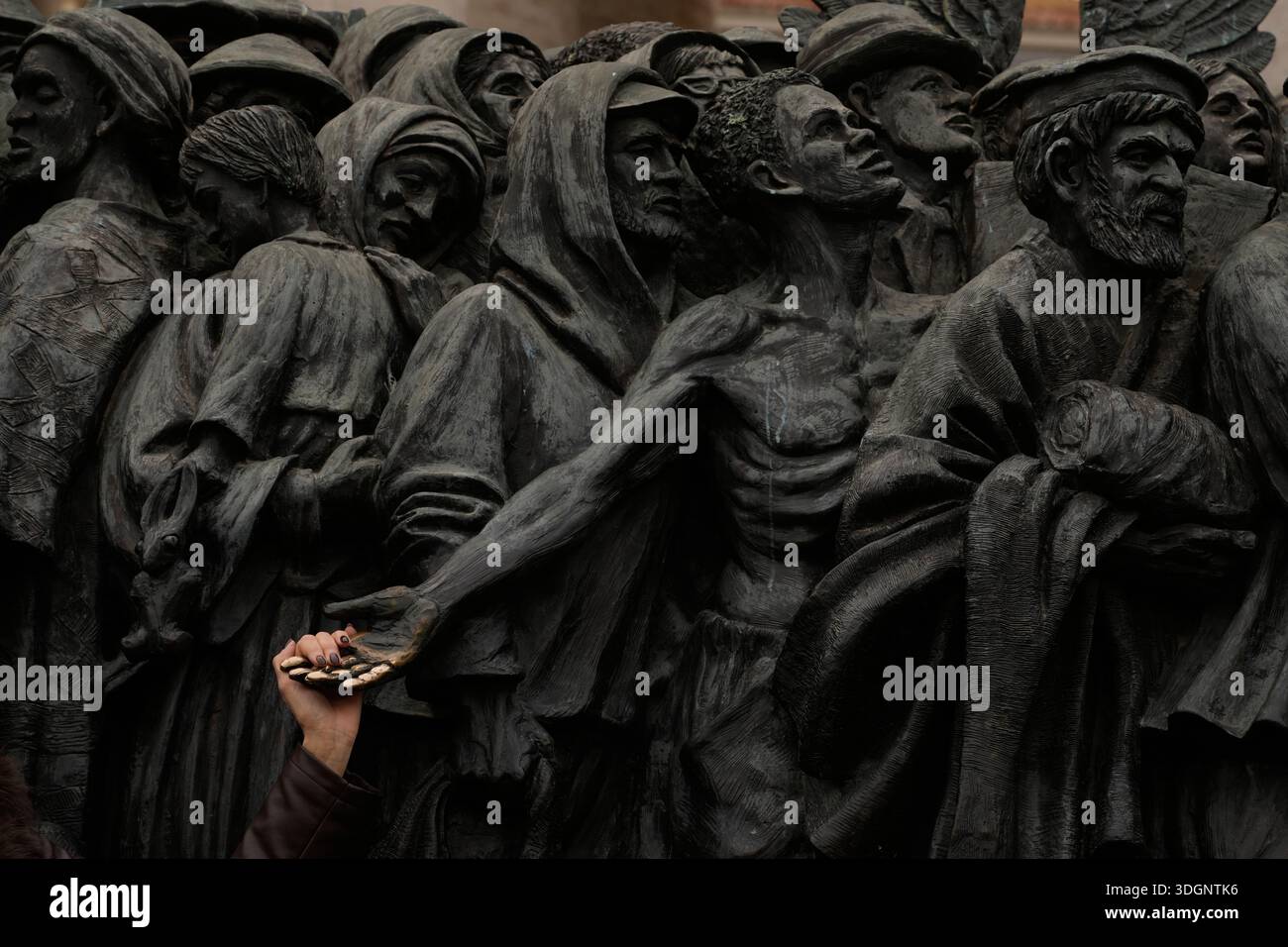 A woman touches the bronze sculpture "Angels Unawares," by Canadian ...