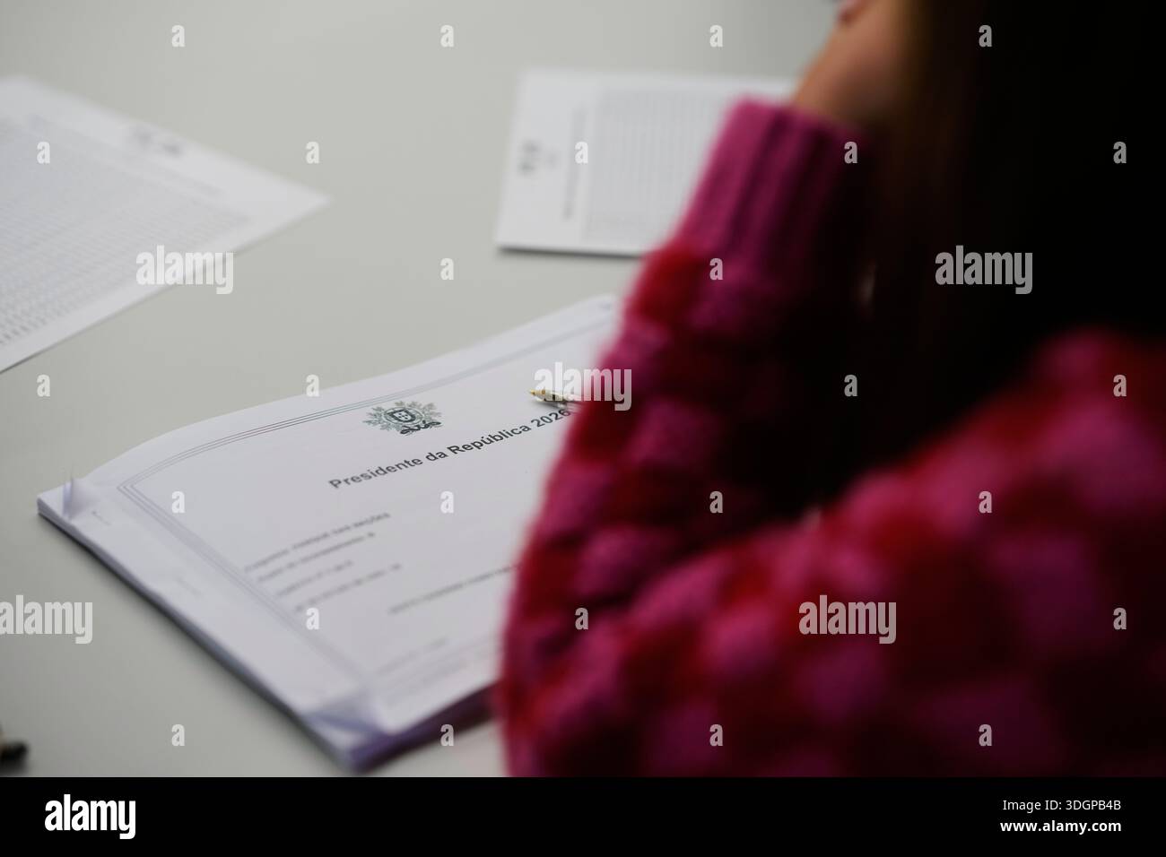 An election official waits for voters to arrive to cast their ballots ...