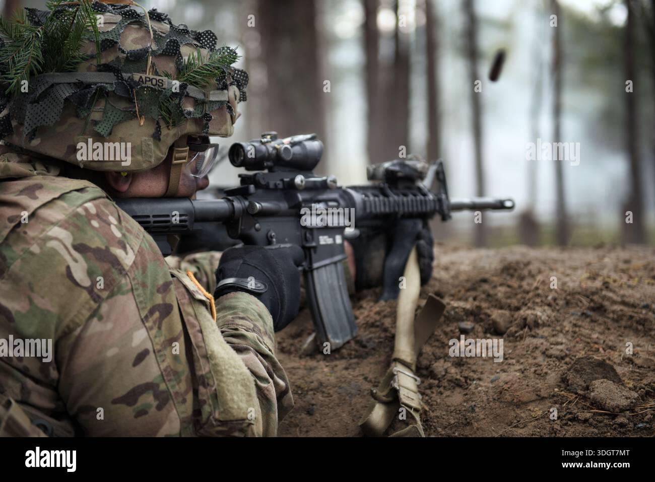 Soldier aiming rifle in forest during military training exercise Stock ...