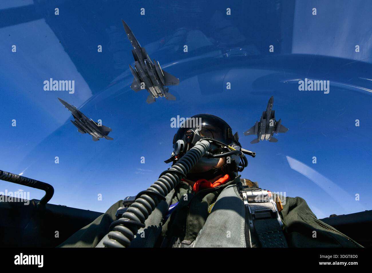 POV shot from inside a fighter jet cockpit showing a pilot wearing a ...