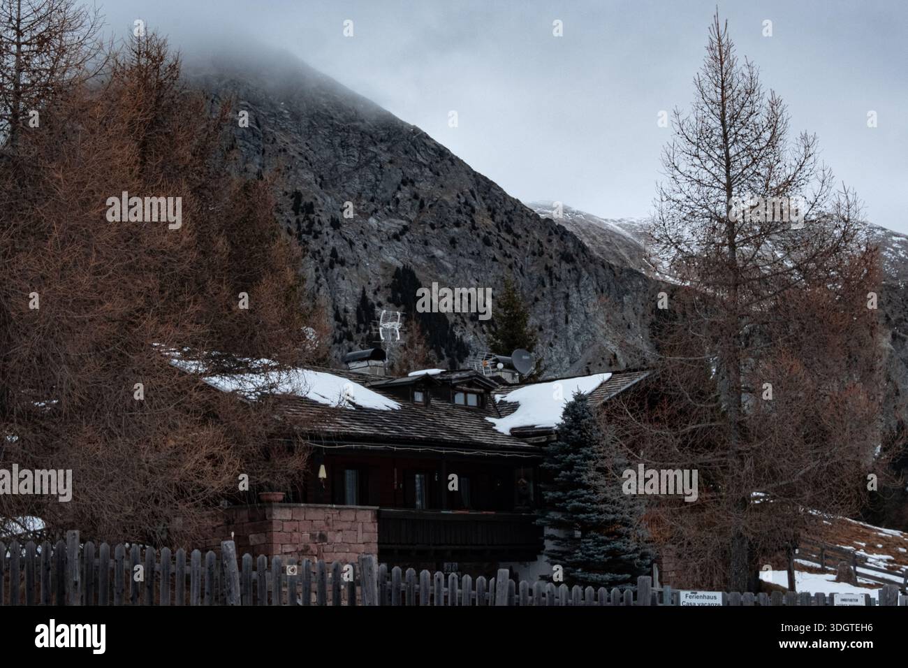Rustic Alpine Cabin with Snowy Mountain Slope and Winter Trees Stock ...