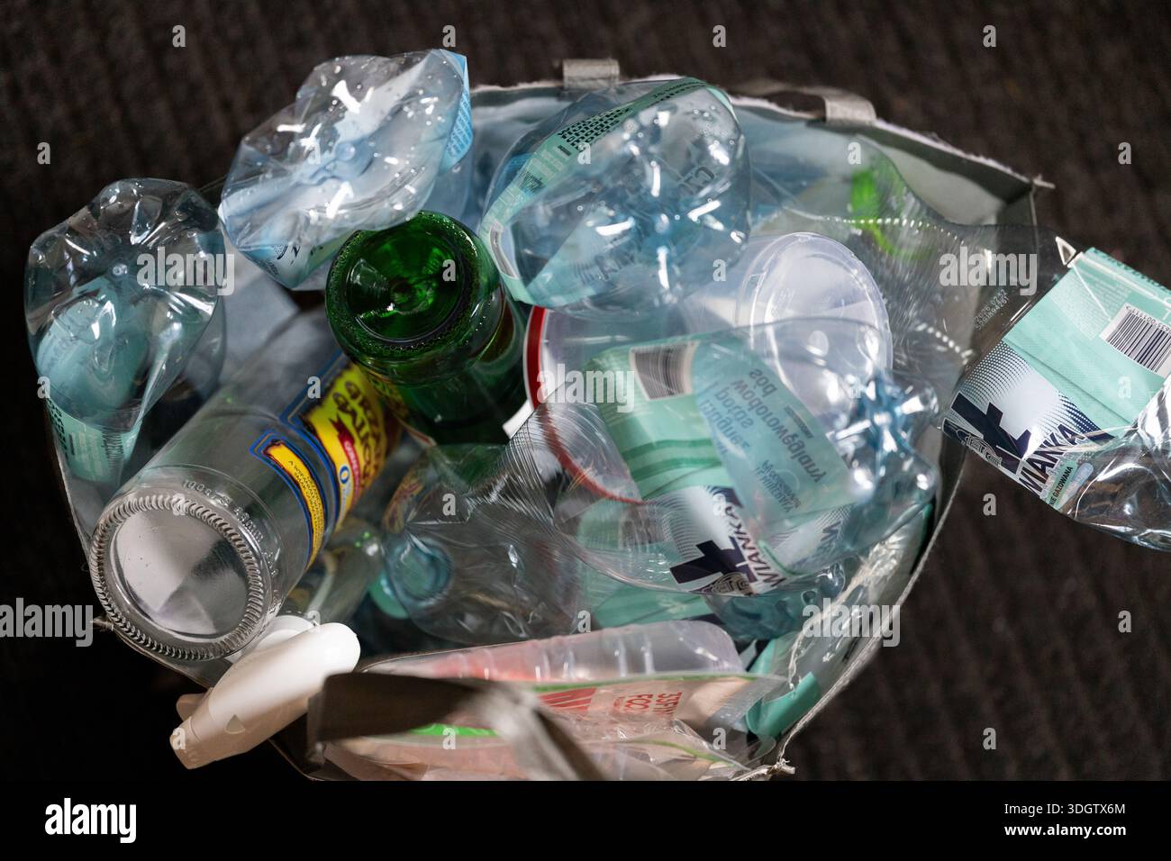 Collecting waste in a bag at a recycling center in the afternoon Stock ...