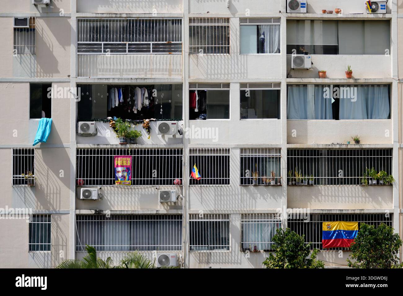 A poster of former President Nicolas Maduro hangs out of a window in ...