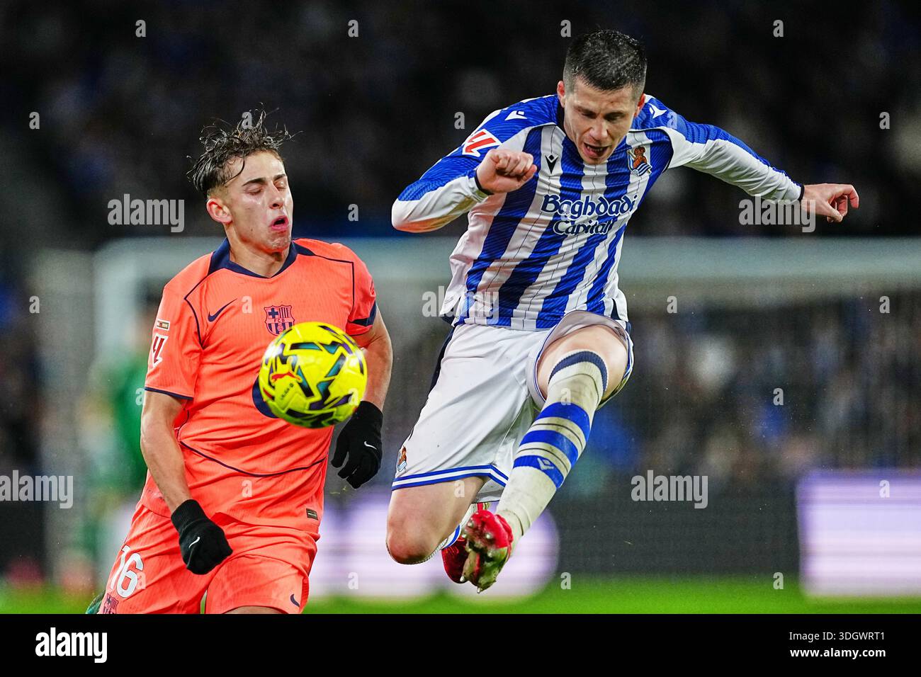 Barcelona's Fermin Lopez, left, challenges for the ball with Real ...