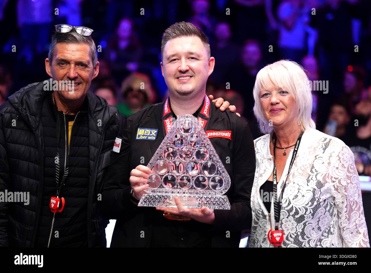 Kyren Wilson (centre) celebrates with the Paul Hunter Trophy and ...