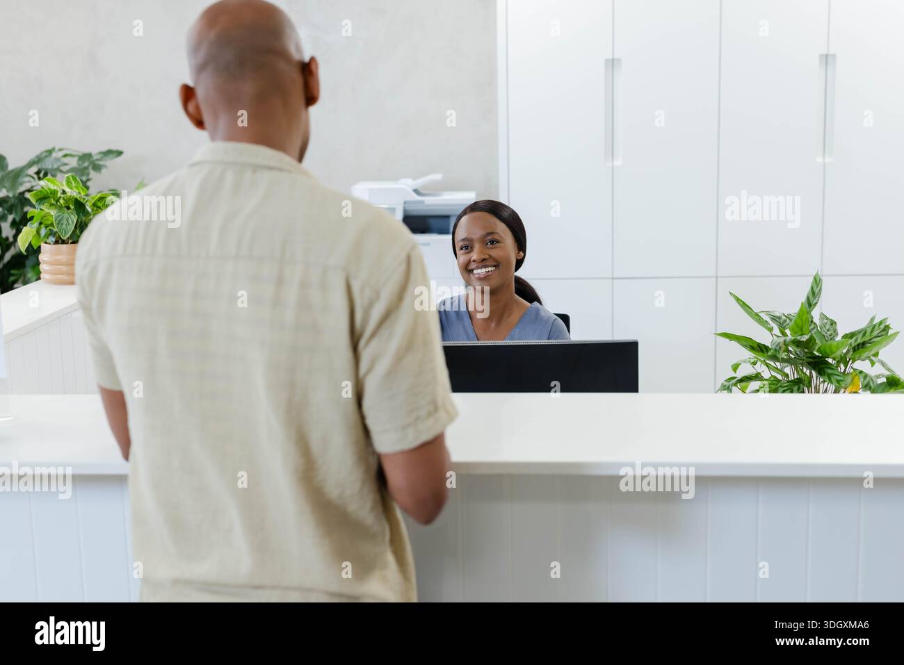 Reception desk with a computer sitting on top hi-res stock photography ...