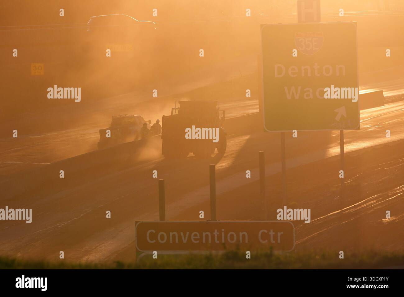 Dust rises as road construction crews work on a closed interstate that ...
