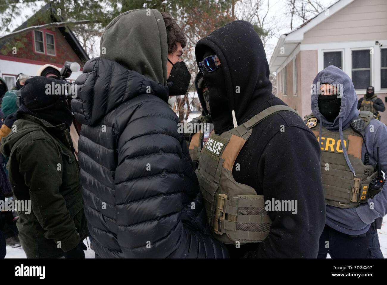 A protester, left, and a federal law enforcement officer argue outside ...
