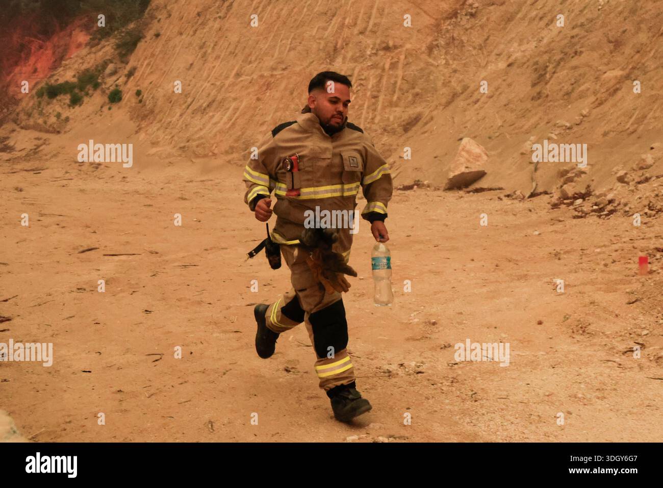 A firefighter run as a wildfire in Concepcion, Chile on Jan. 18, 2026 ...