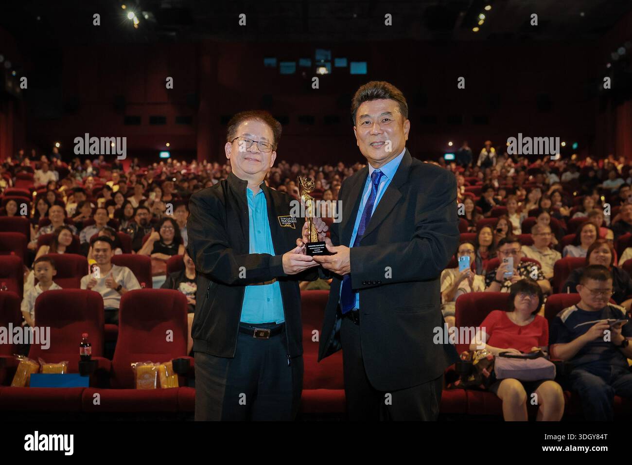 Singapore Film Society chairman Kenneth Tan (left) presenting its first ...
