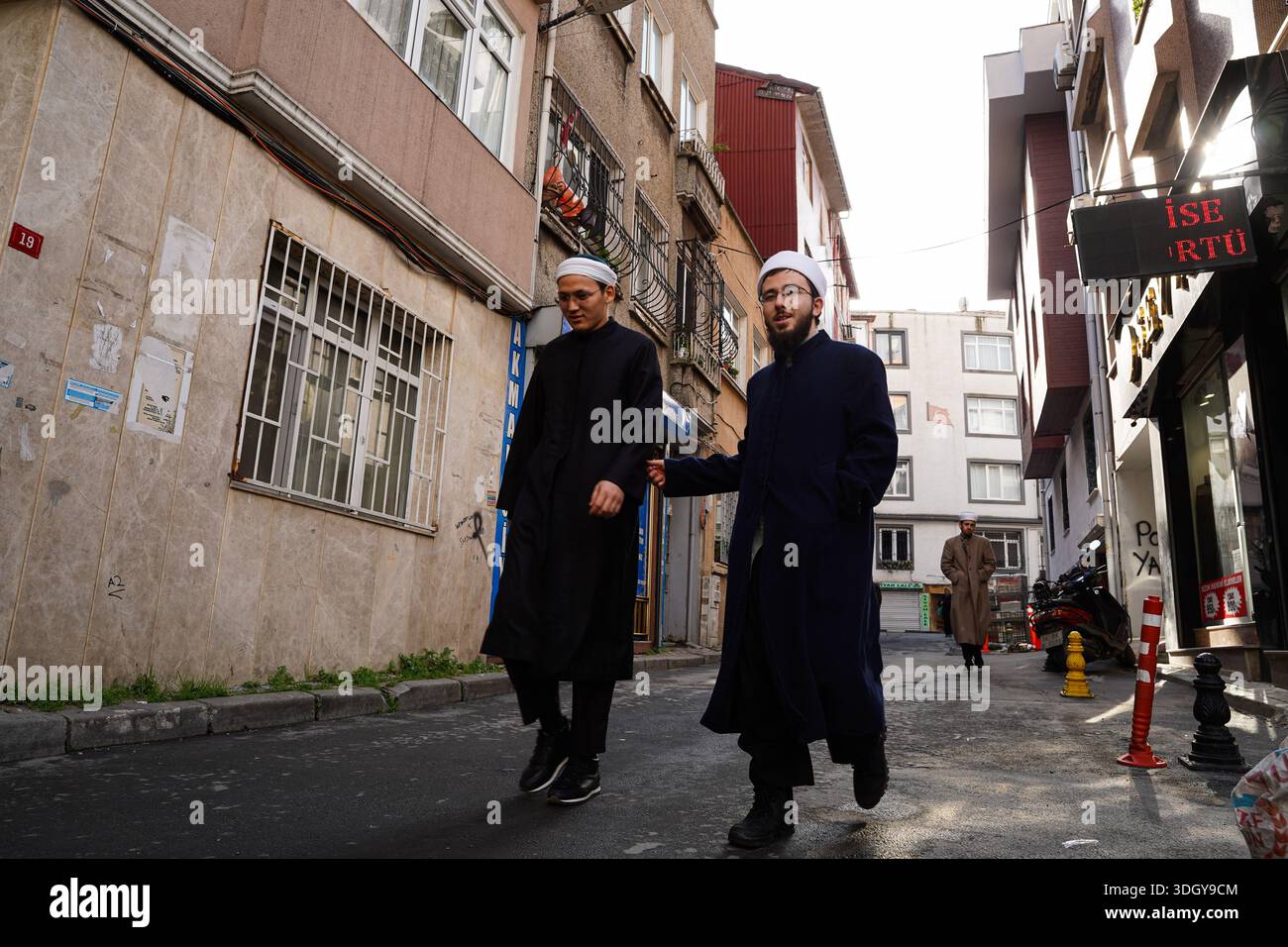 Two Muslim men walk down an alley in the Balat neighborhood of the ...