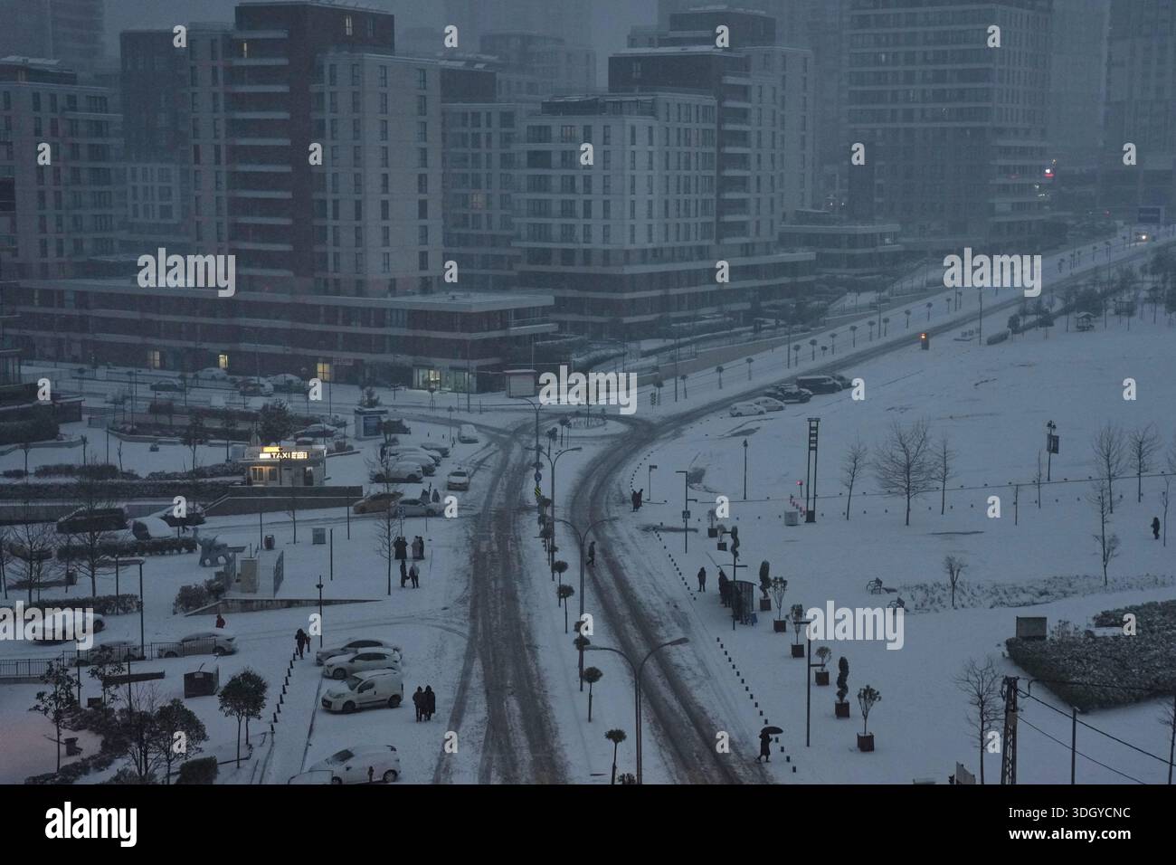 People walk during a snowfall in Istanbul, Turkey, Monday, Jan. 19 ...