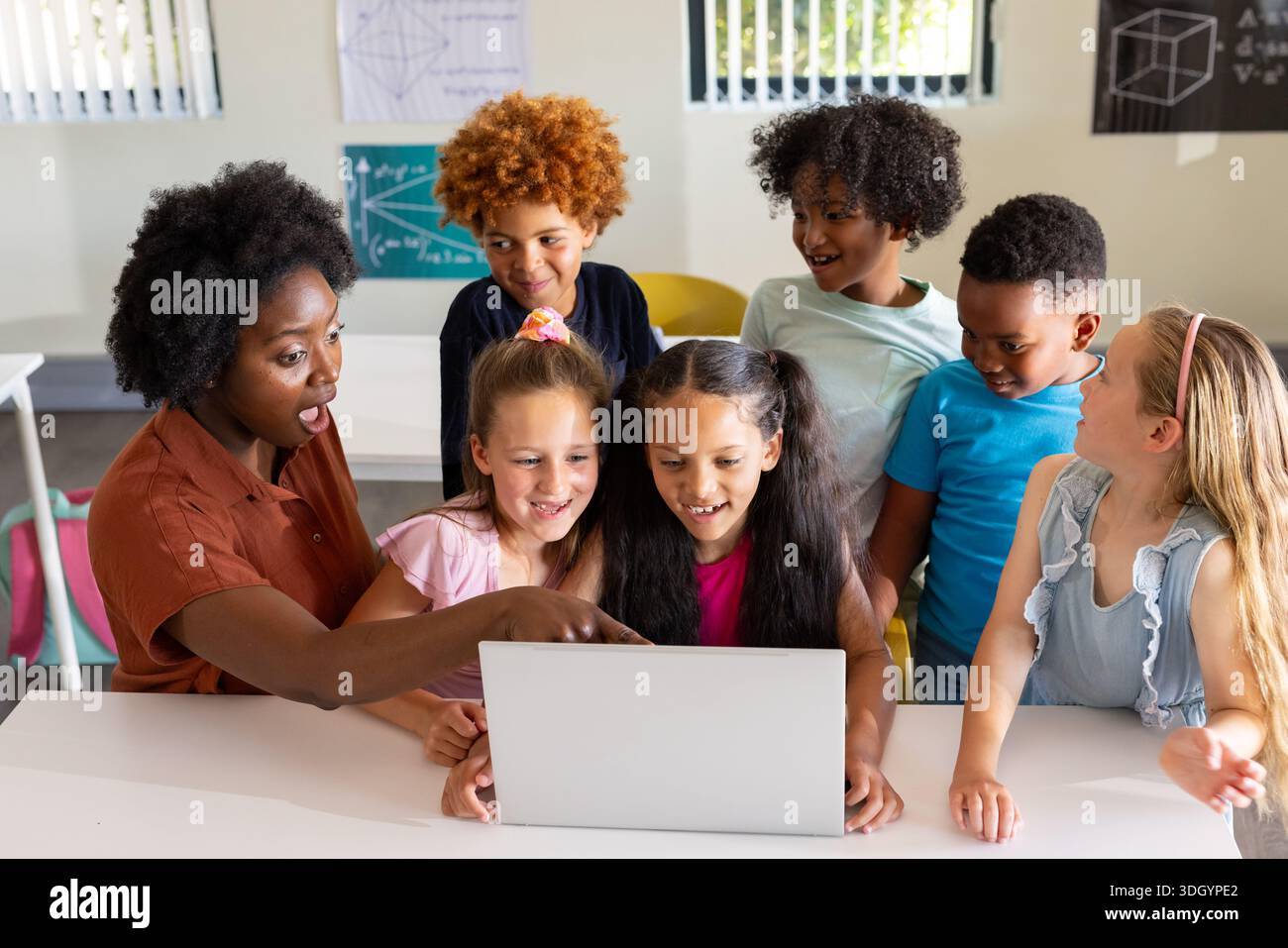 African American teacher with diverse children pointing at silver ...