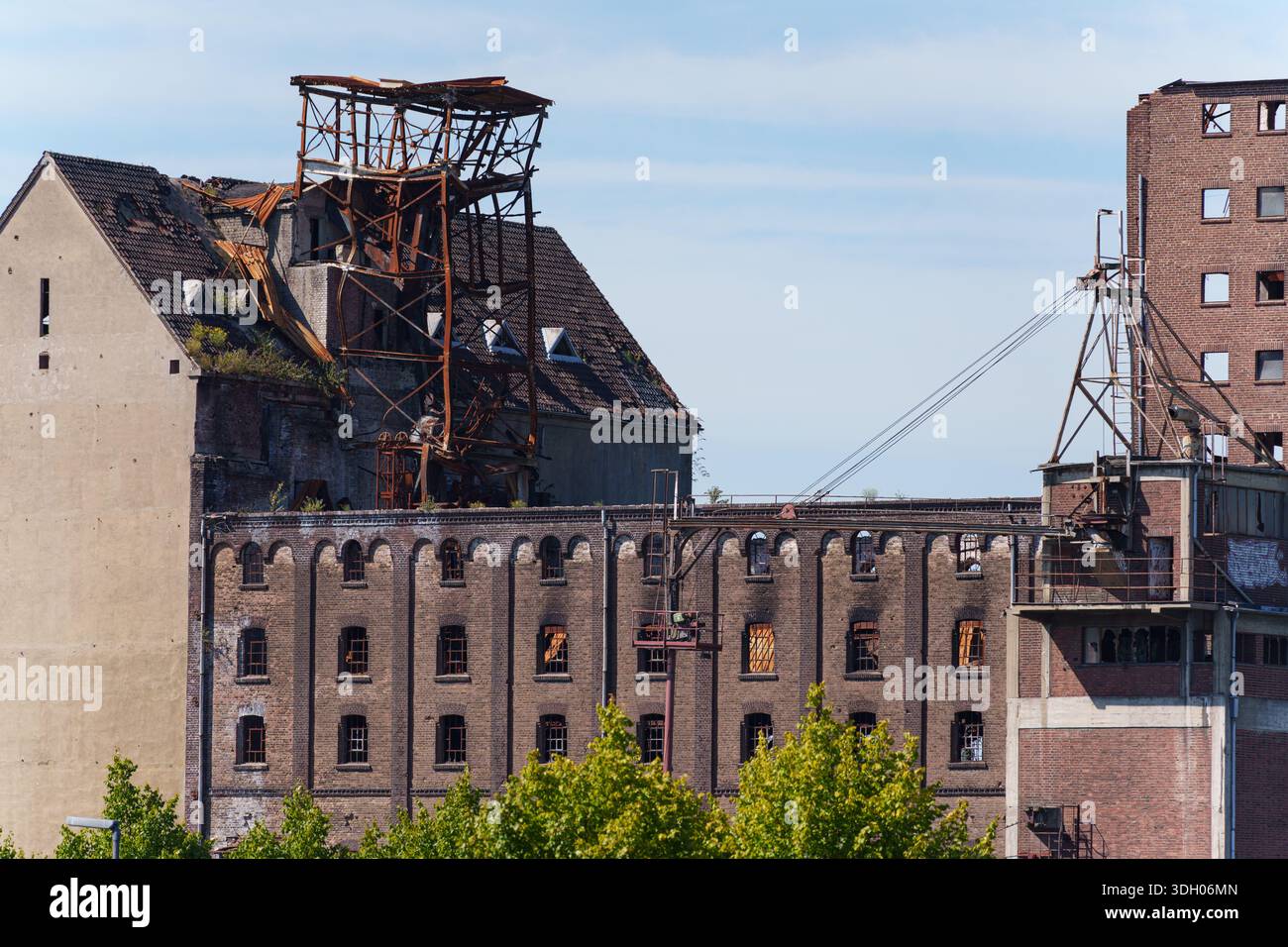 An old abandoned industrial building made of red brick with a collapsed ...