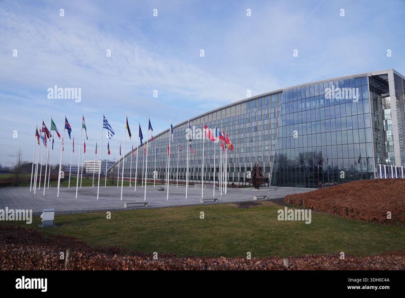Flags flap in the wind outside NATO headquarters in Brussels, Monday ...