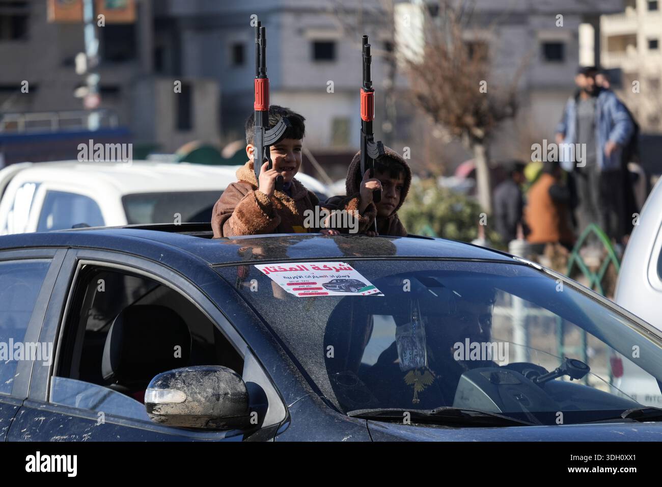 Ar Raqqah, Syria. 19th Jan, 2026. Children hold gun toys as they are ...