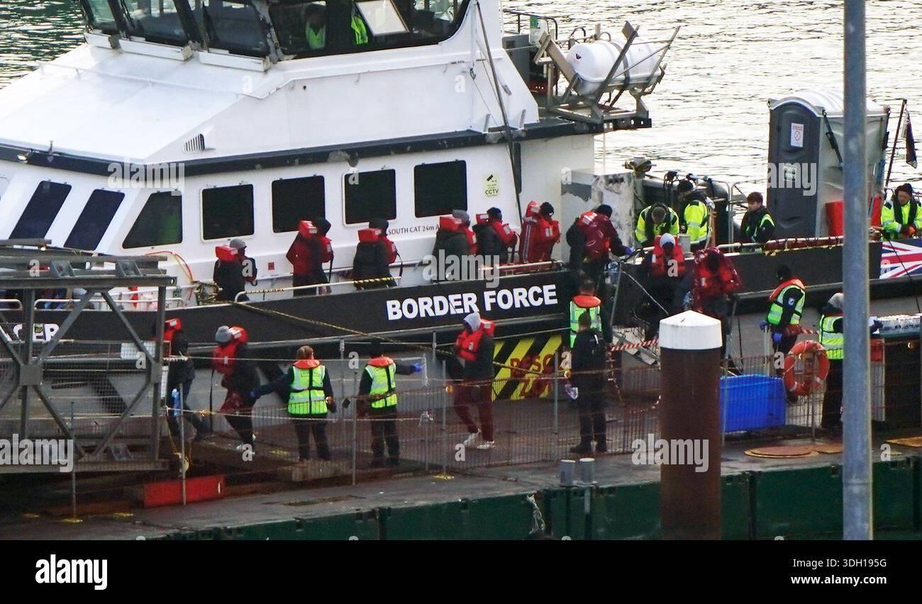 A group of people thought to be migrants are brought in to the Border ...