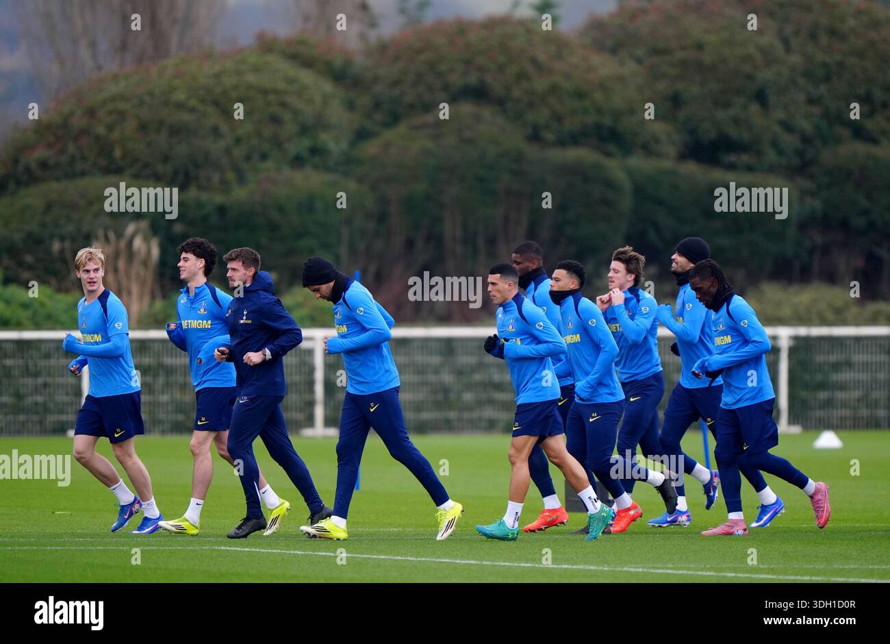 Tottenham Hotspur players warm up during a training session at the ...