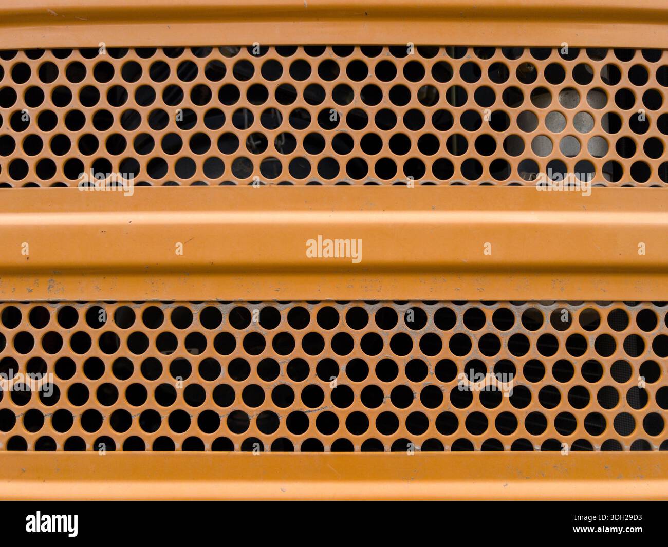 Orange metallic safety grill on construction equipment Stock Photo - Alamy