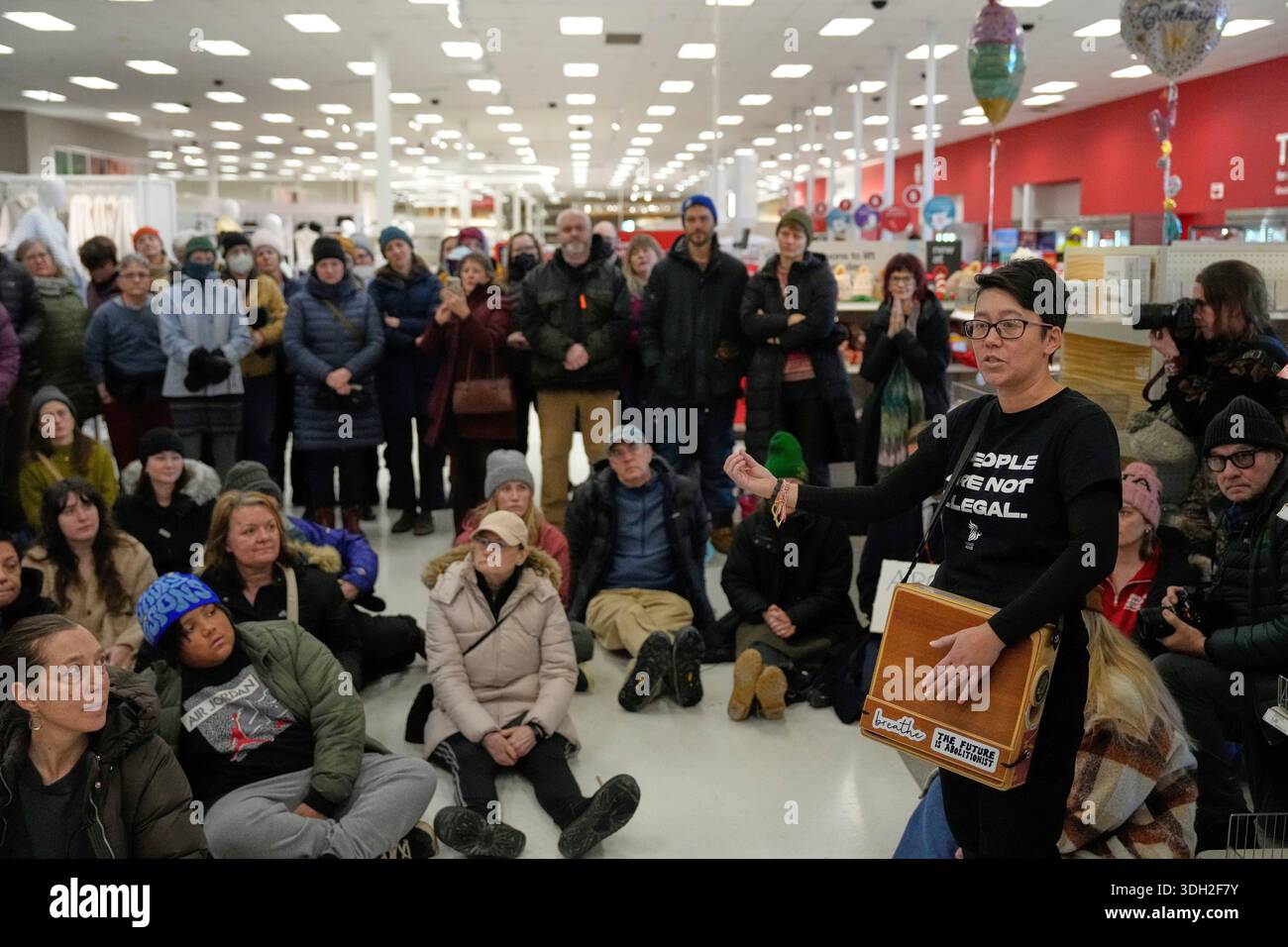 Community members and neighbors of people detained by ICE protest at a ...