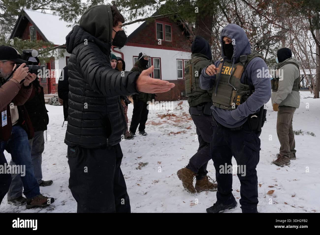 A protester, left, and a federal law enforcement officer argue outside ...