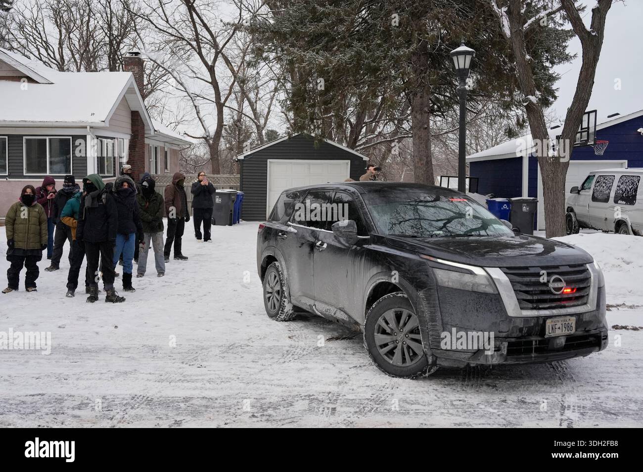 Protesters gather as federal law enforcement officers leave a house ...