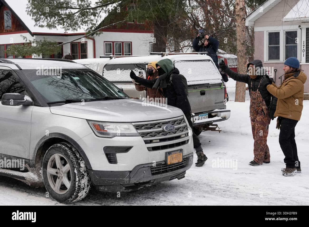 Protesters gather as federal law enforcement officers leave a house ...